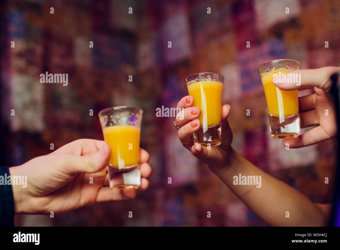 Girls making a toast with tequila shots Stock Photo - Alamy