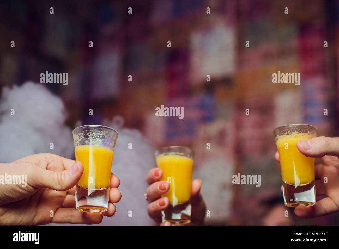 Girls making a toast with tequila shots Stock Photo - Alamy