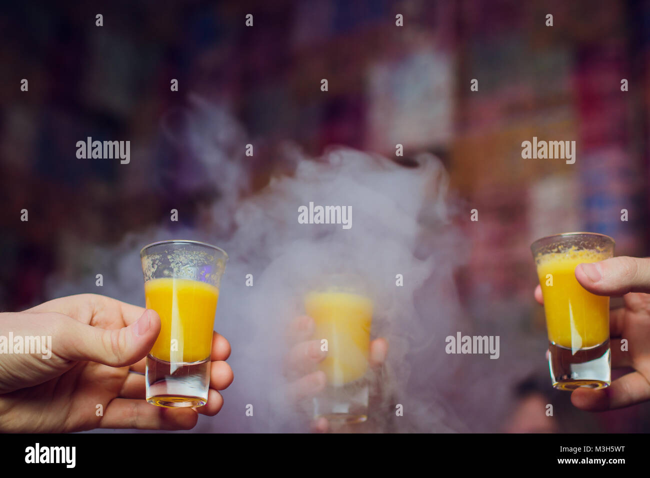 Girls making a toast with tequila shots Stock Photo - Alamy