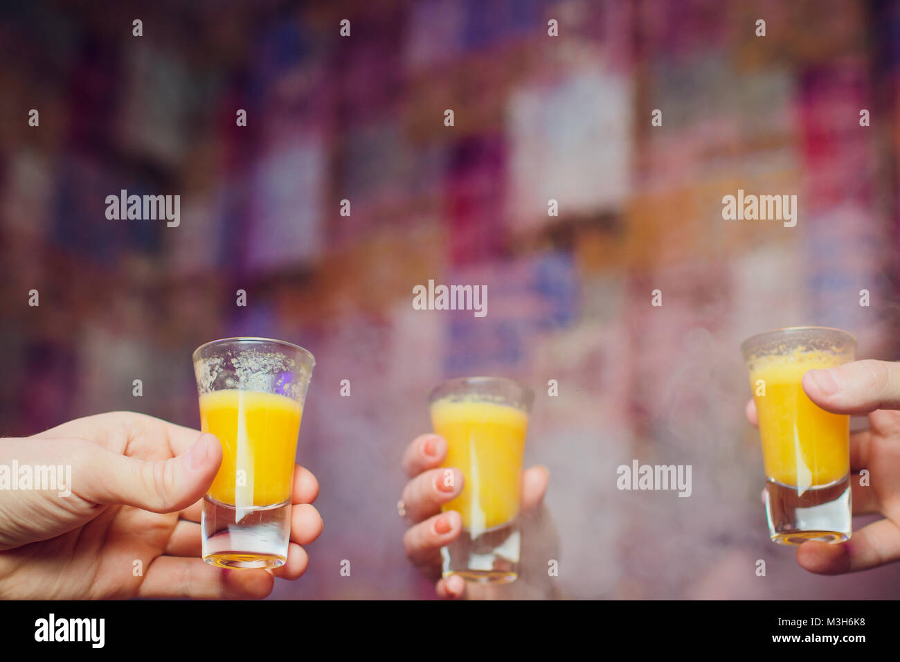 Girls making a toast with tequila shots Stock Photo - Alamy