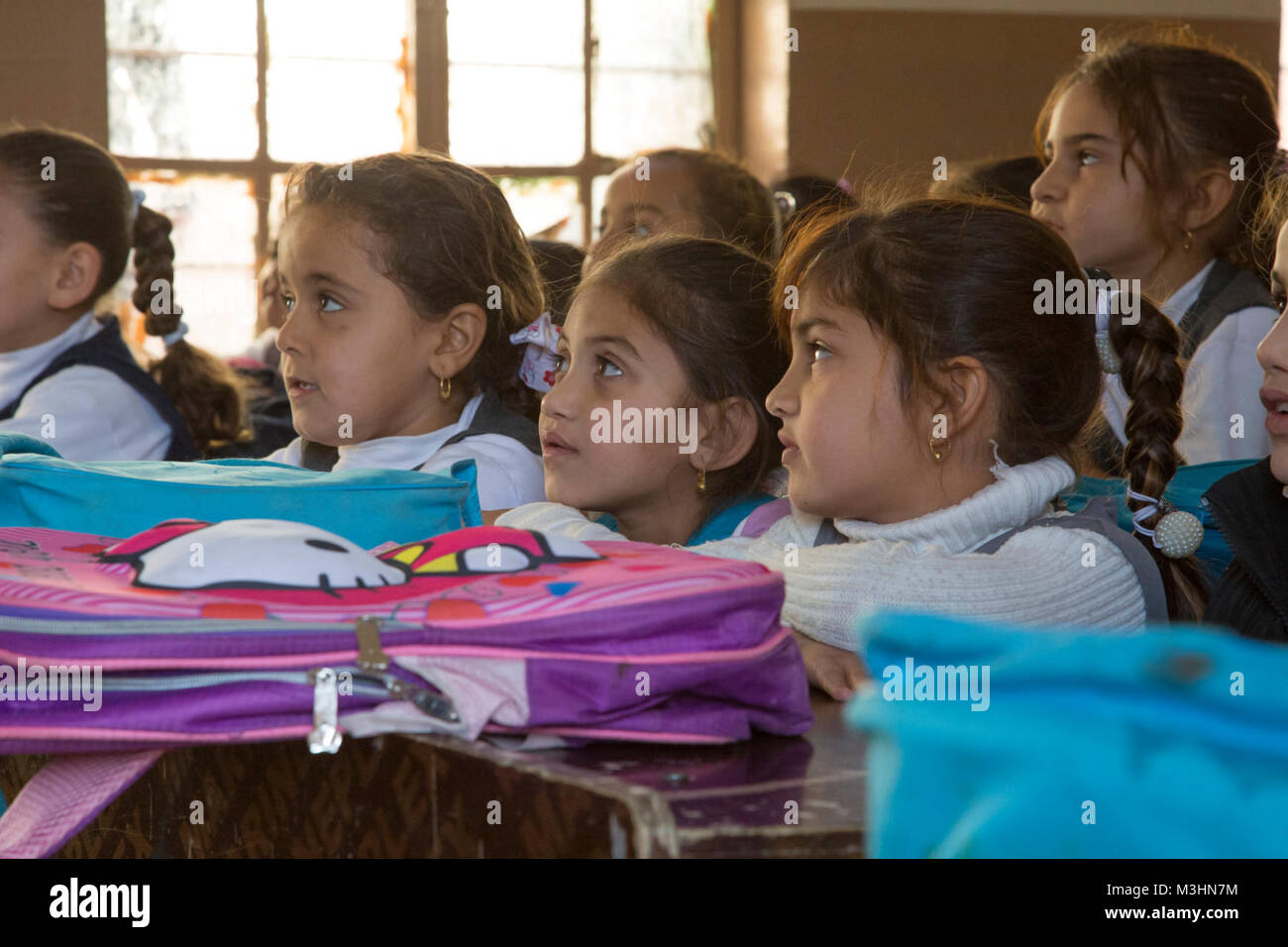 Young Iraqi students listen to their teacher at a primary school, Aski ...