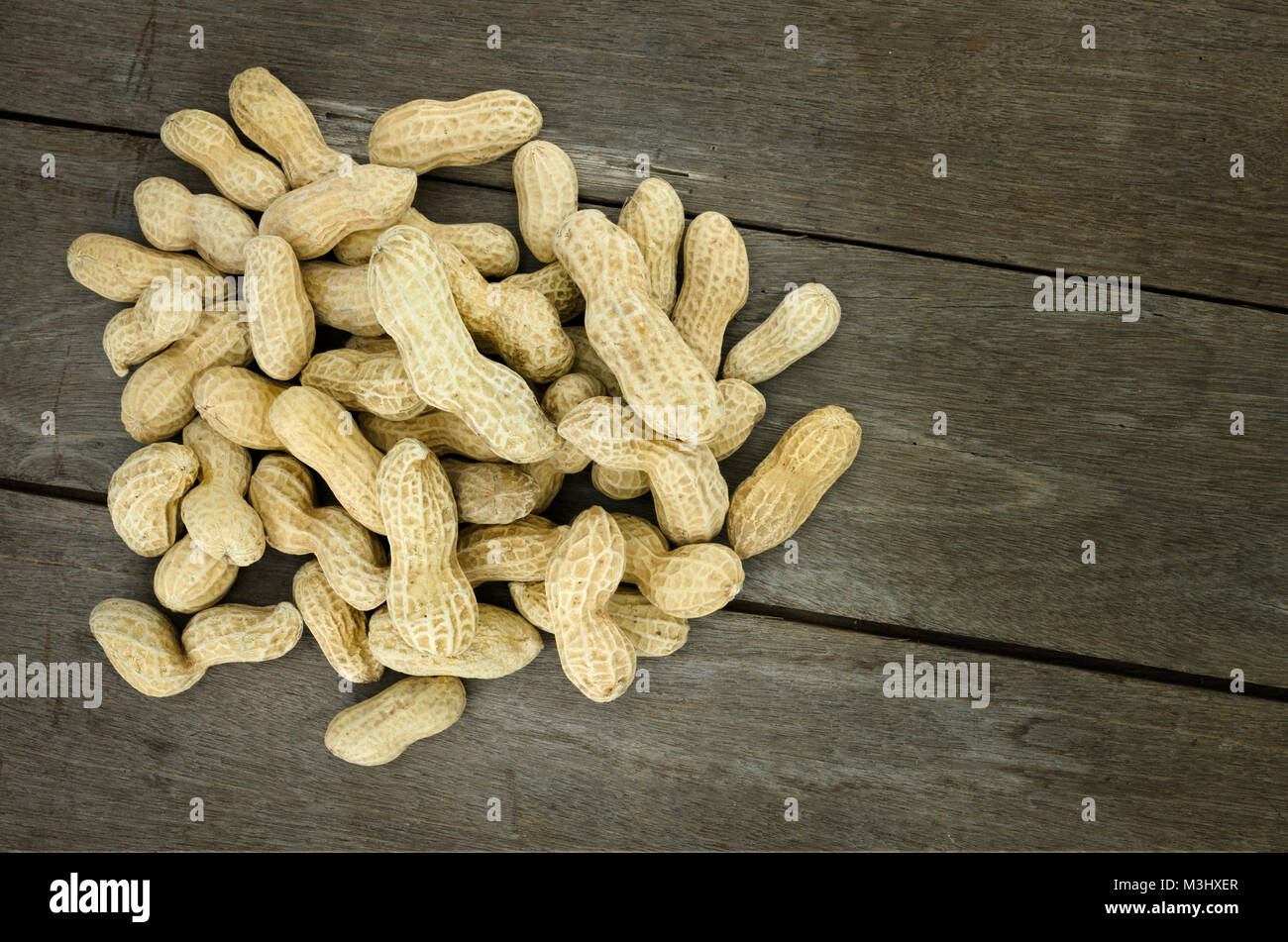 Close up of peanut or groundnut on wooden background for food allergy ...