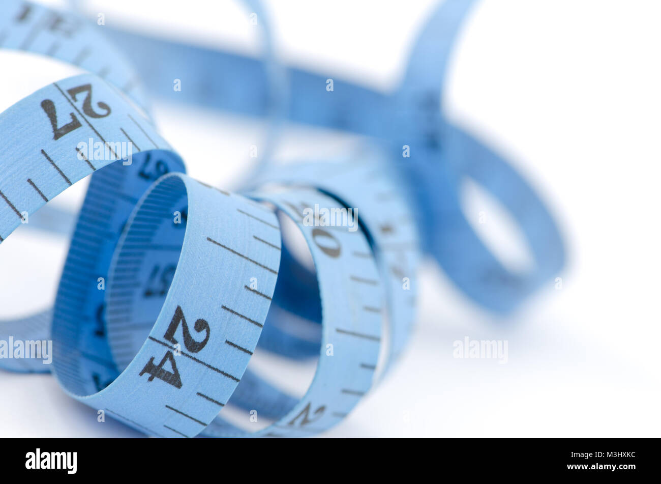 Close up of blue measuring tape for health concept, isolated on white ...
