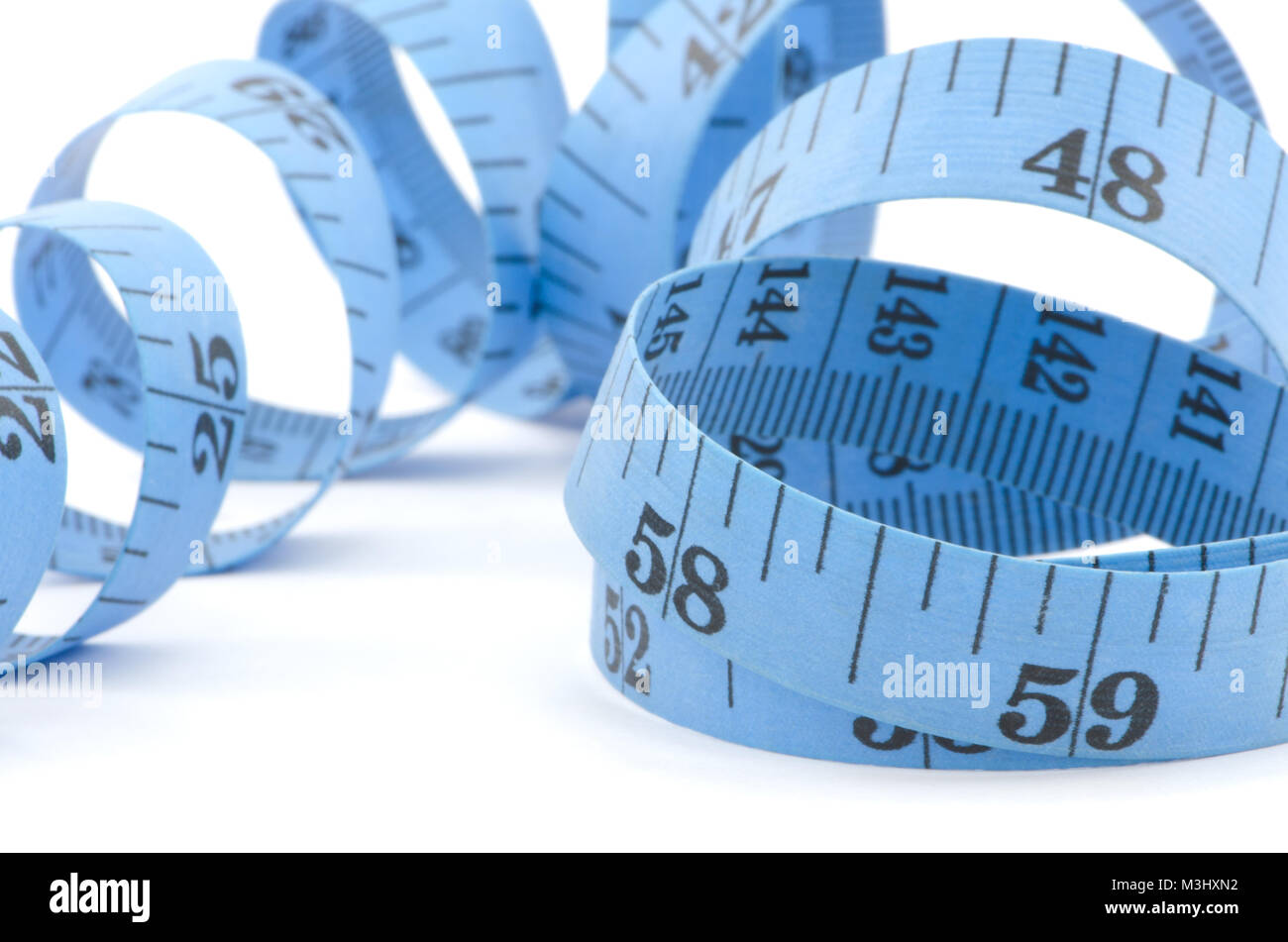 Close up of blue measuring tape for health concept, isolated on white ...
