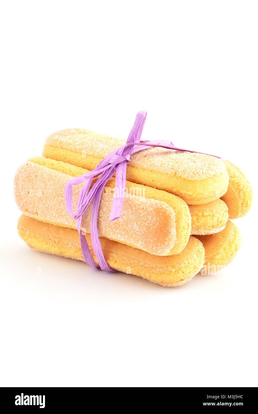 Delicate ladyfinger cookies tied with purple raffia on white background ...