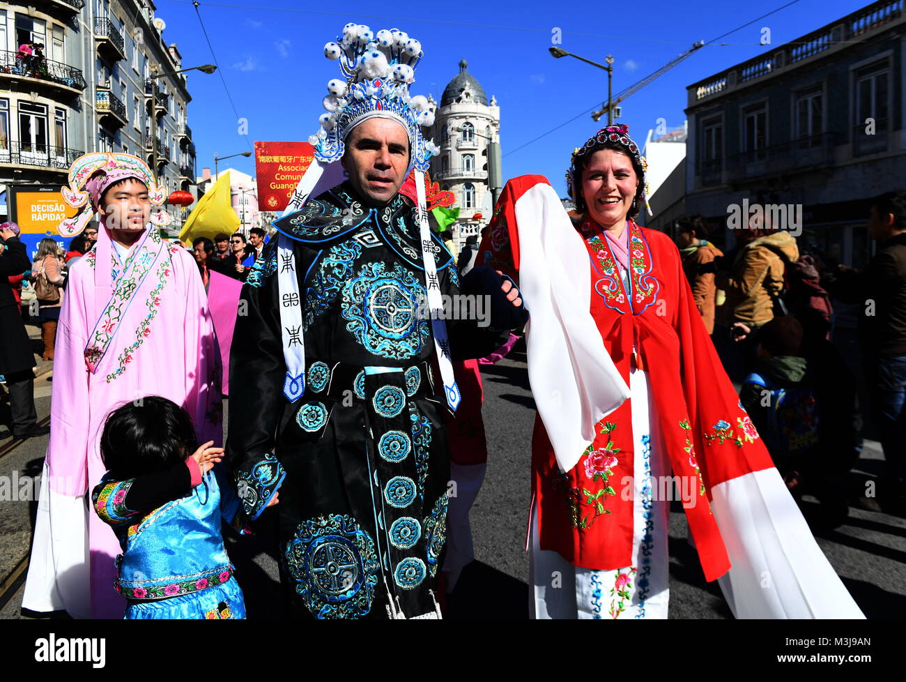Lisbon. 10th Feb, 2018. Portuguese in Chinese costumes walk in a street ...