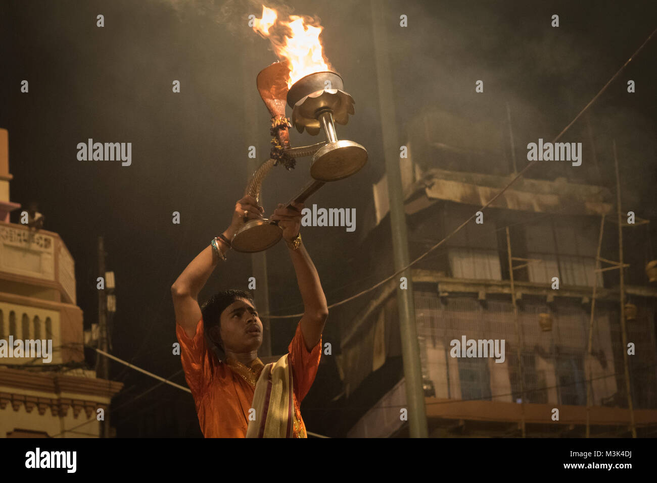 A man holds a lantern aloft a during a nightly ceremony at Dasaswamedh ...