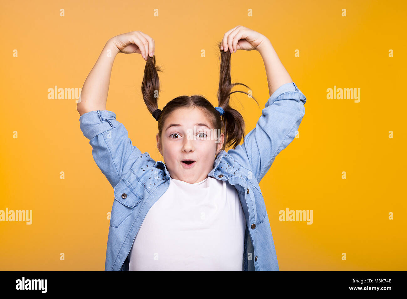 Cute teenage girl rising her hairs up Stock Photo - Alamy