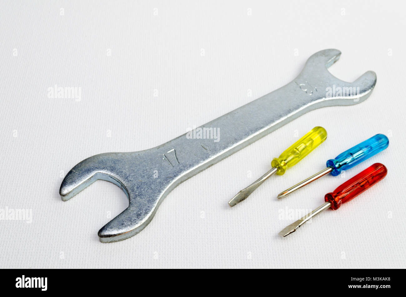 A Studio Photograph of an Open Ended Metal Spanner and Screwdrivers ...