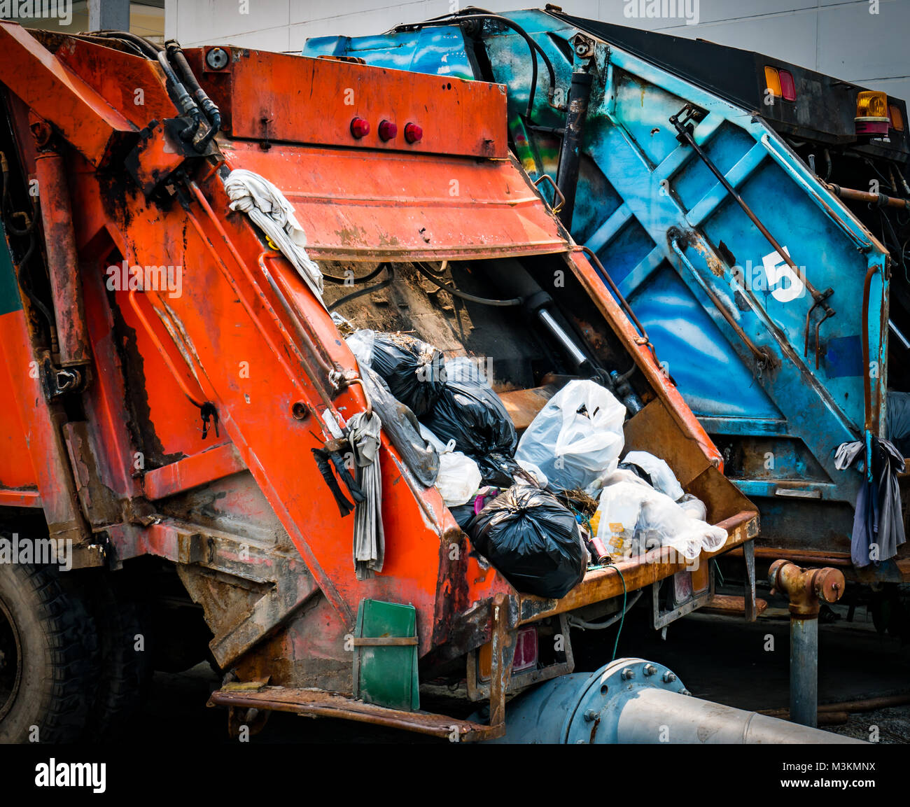 Back of old garbage truck with waste. Urban waste management concept ...