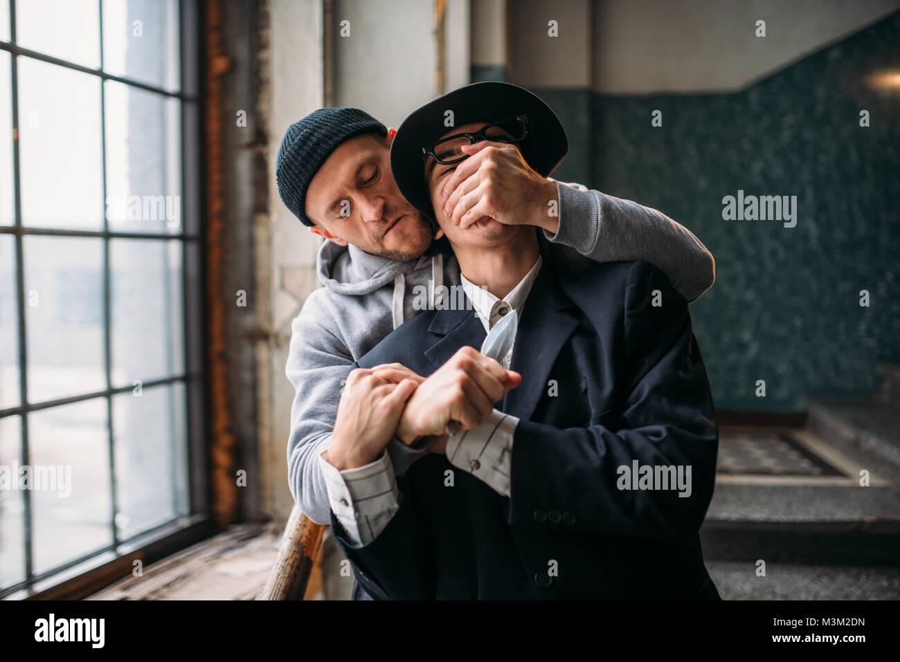 Aggressive addict with knife attack his victim. Street gangster commits ...