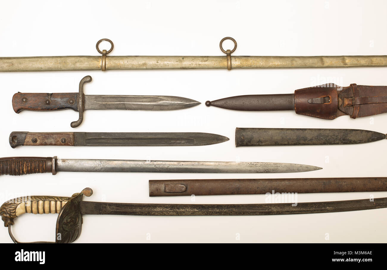 Armoury display of historic swords, knives and daggers in a close up ...