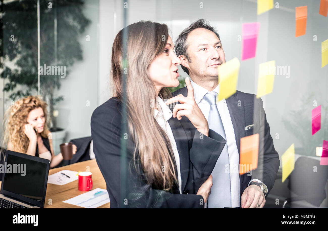 Office people working and talking about business plans Stock Photo - Alamy