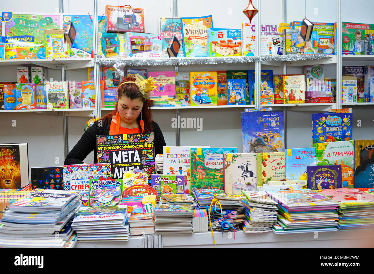 Booksellers waiting for customers at a bookshop counter. Book Fair ...