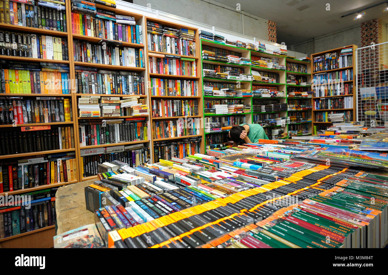 Booksellers waiting for customers at a bookshop counter. Book Fair ...