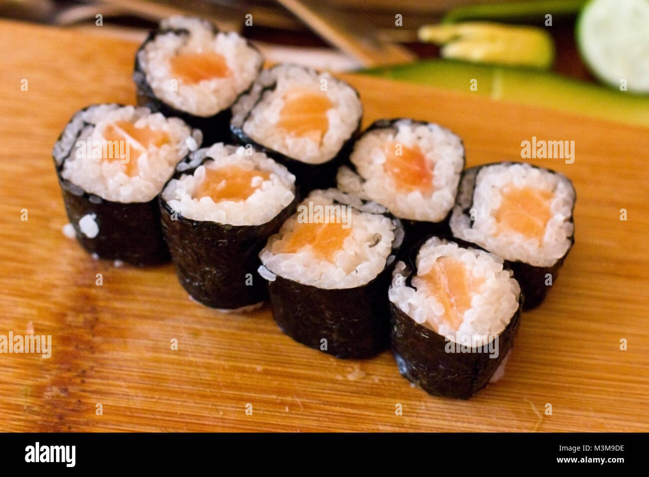 Preparation of Japanese rolls from salmon. Rolls on wooden board Stock ...