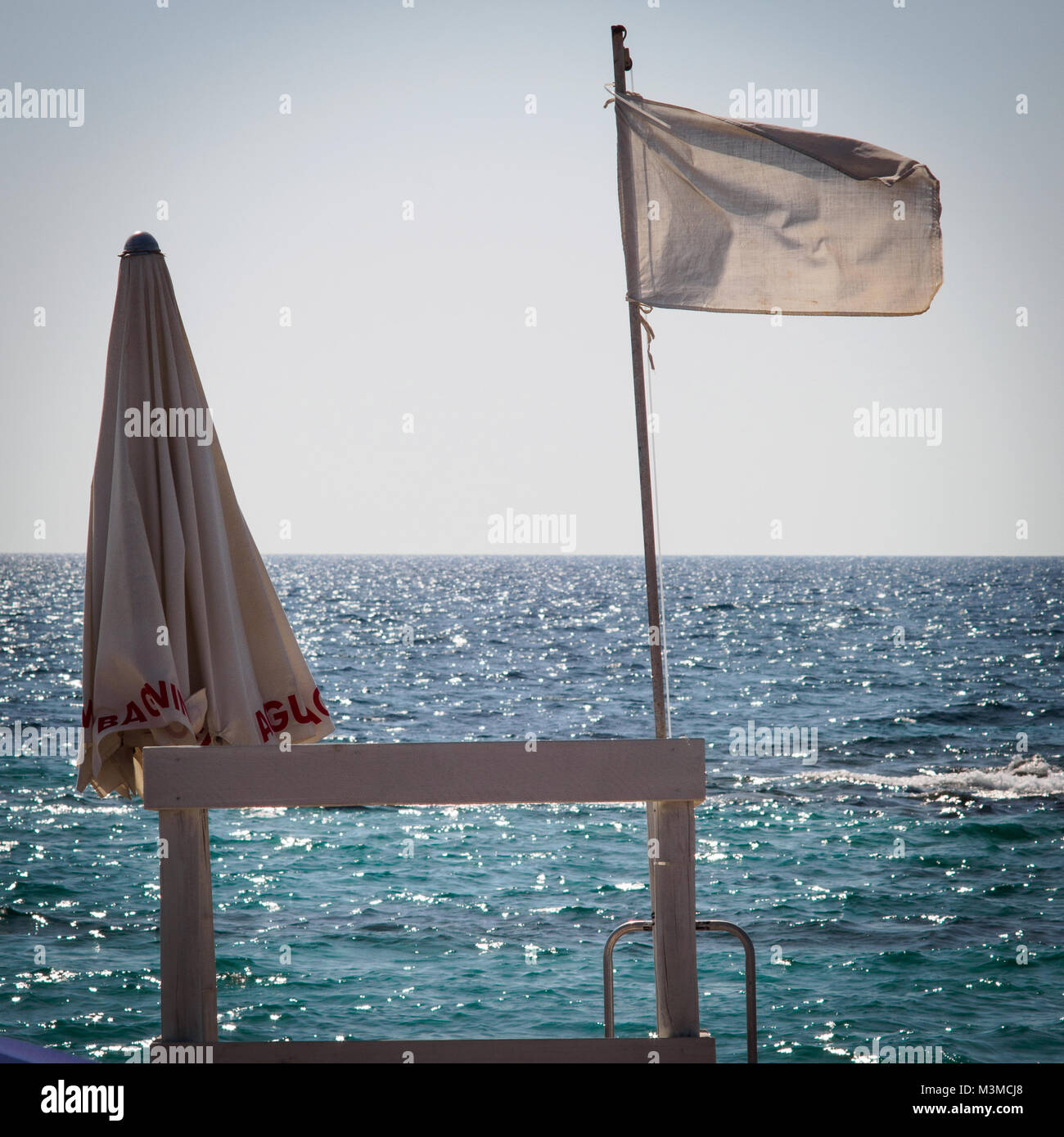 White lifeguard chair blue umbrella hi-res stock photography and images ...
