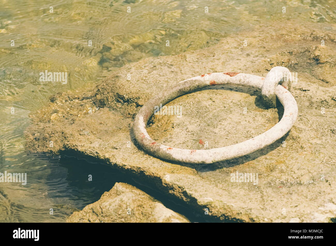 Large Iron Ring in the Rock for Mooring Boat Stock Photo - Alamy