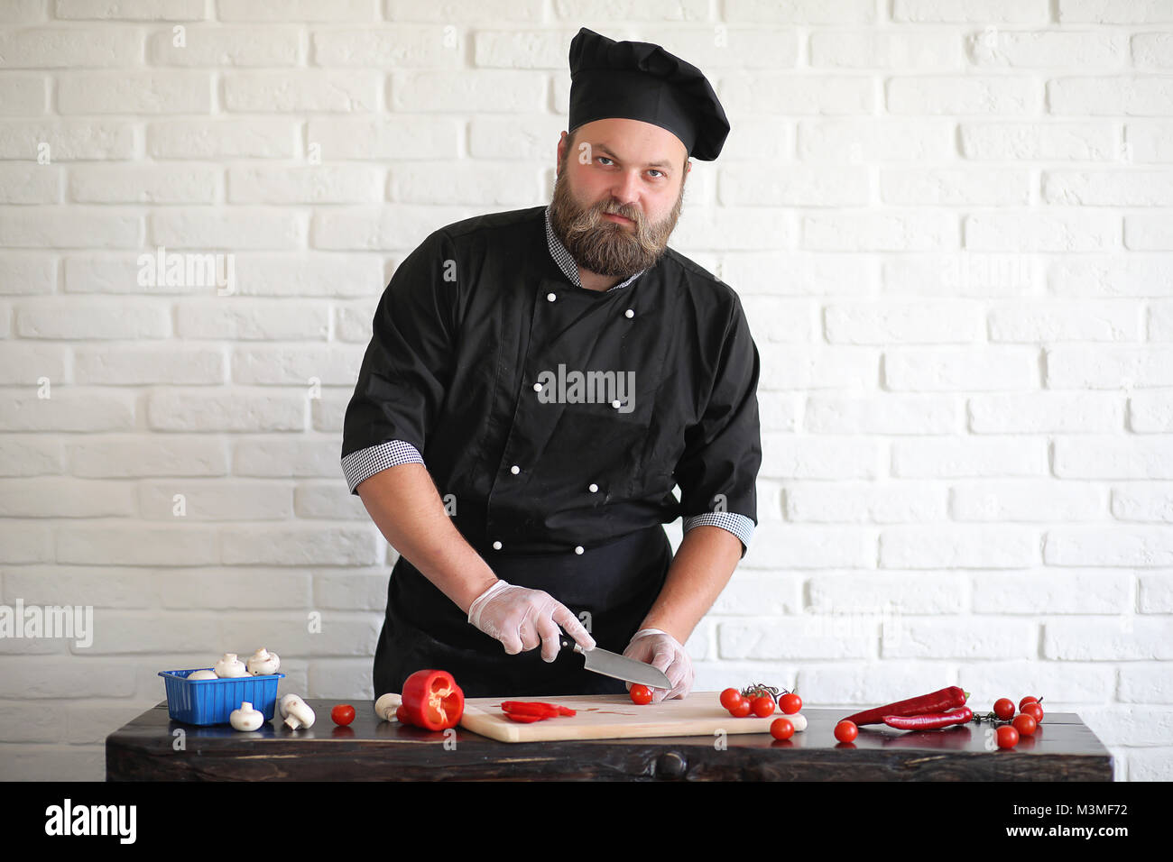 Bearded chef chef prepares meals Stock Photo - Alamy