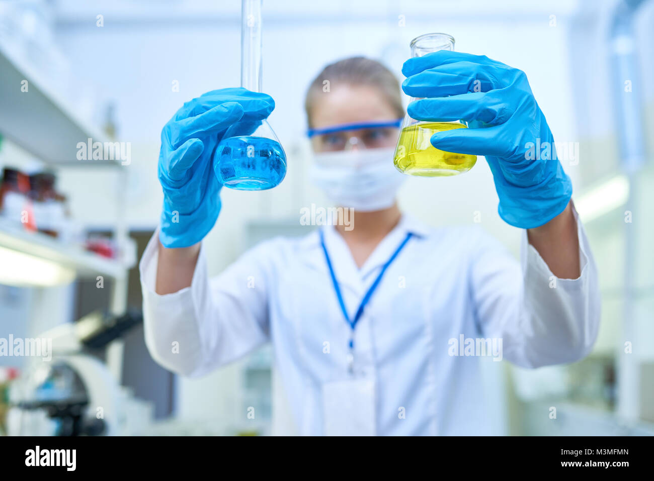 Female Scientist Holding Beakers Stock Photo - Alamy
