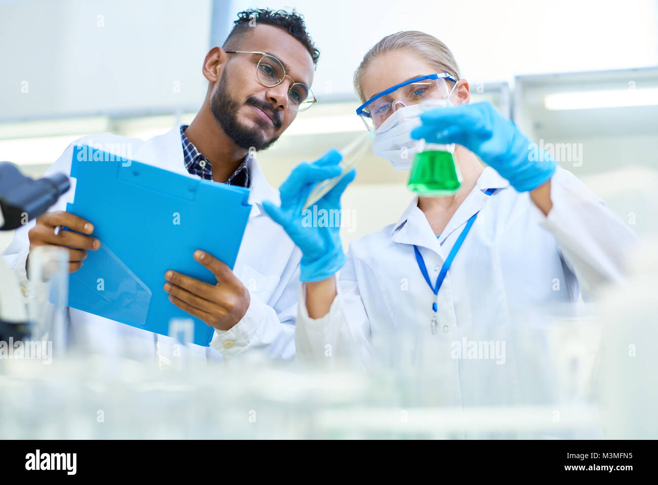 Two Scientists Working in Chemical Laboratory Stock Photo - Alamy