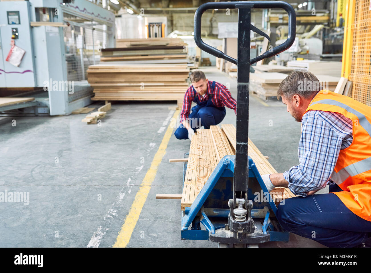 Two Factory Workers Moving Materials Stock Photo - Alamy