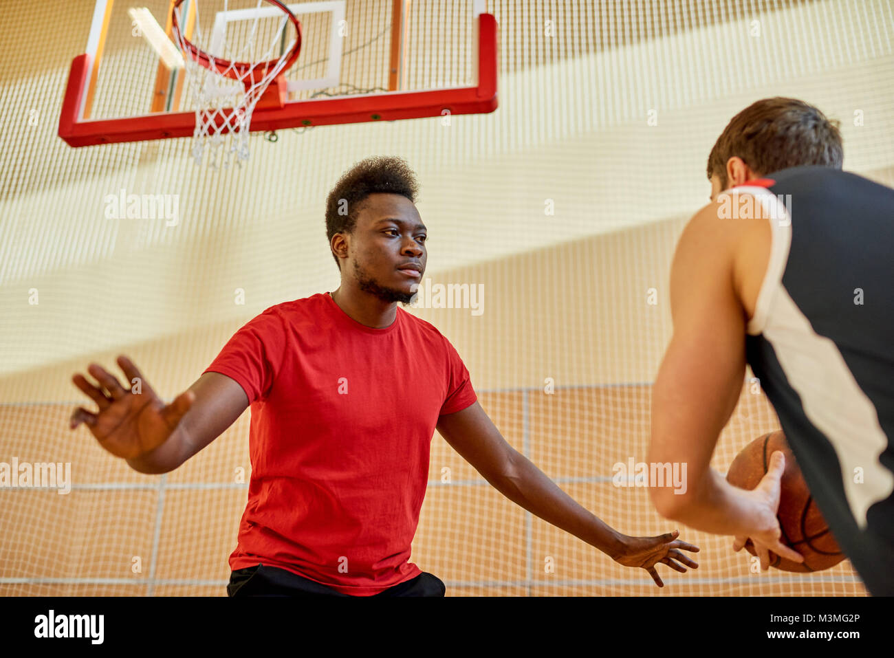 African man playing defense in basketball Stock Photo - Alamy