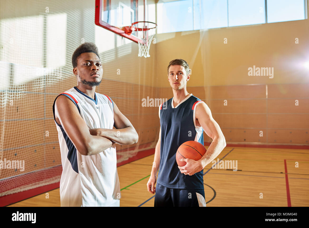 Confident successful leading basketball players on court Stock Photo ...