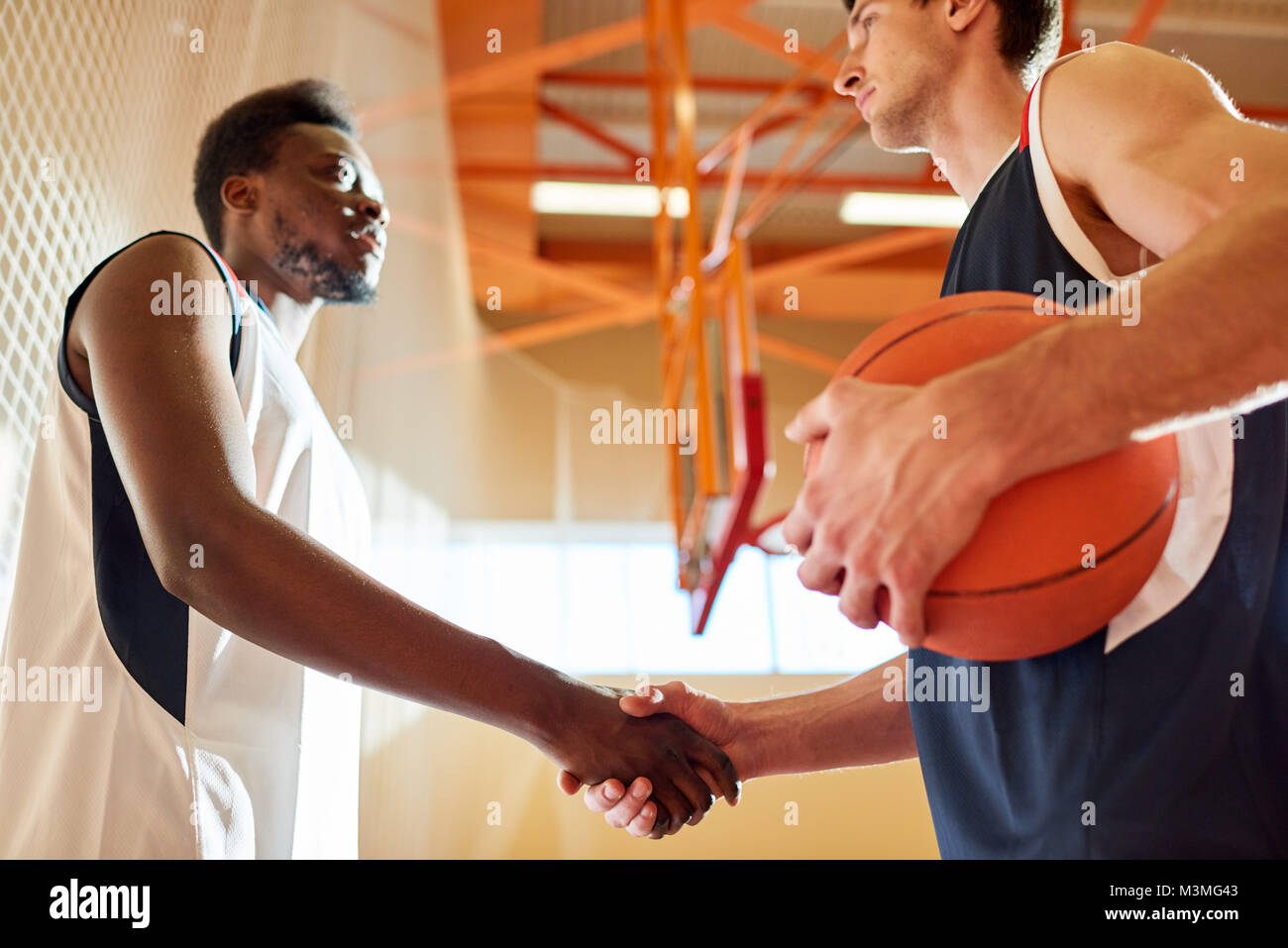 Serious basketball players from different team shaking hands Stock ...