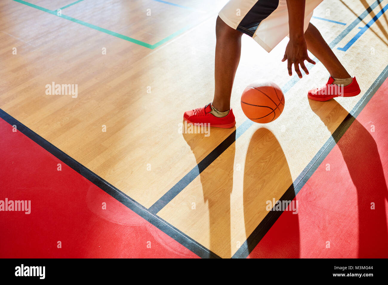 Unrecognizable player dribbling in basketball Stock Photo - Alamy