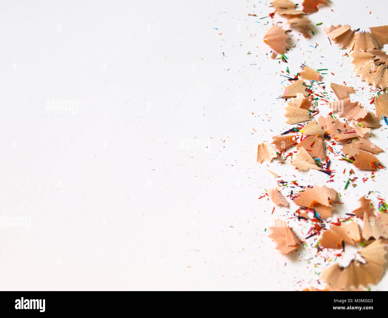 Colorful pencil shavings and pieces on white isolated background. Right ...