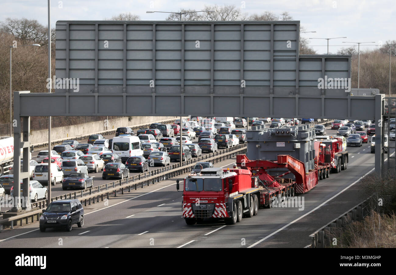 An abnormal load is escorted along the M25 near to Iver as it makes it ...