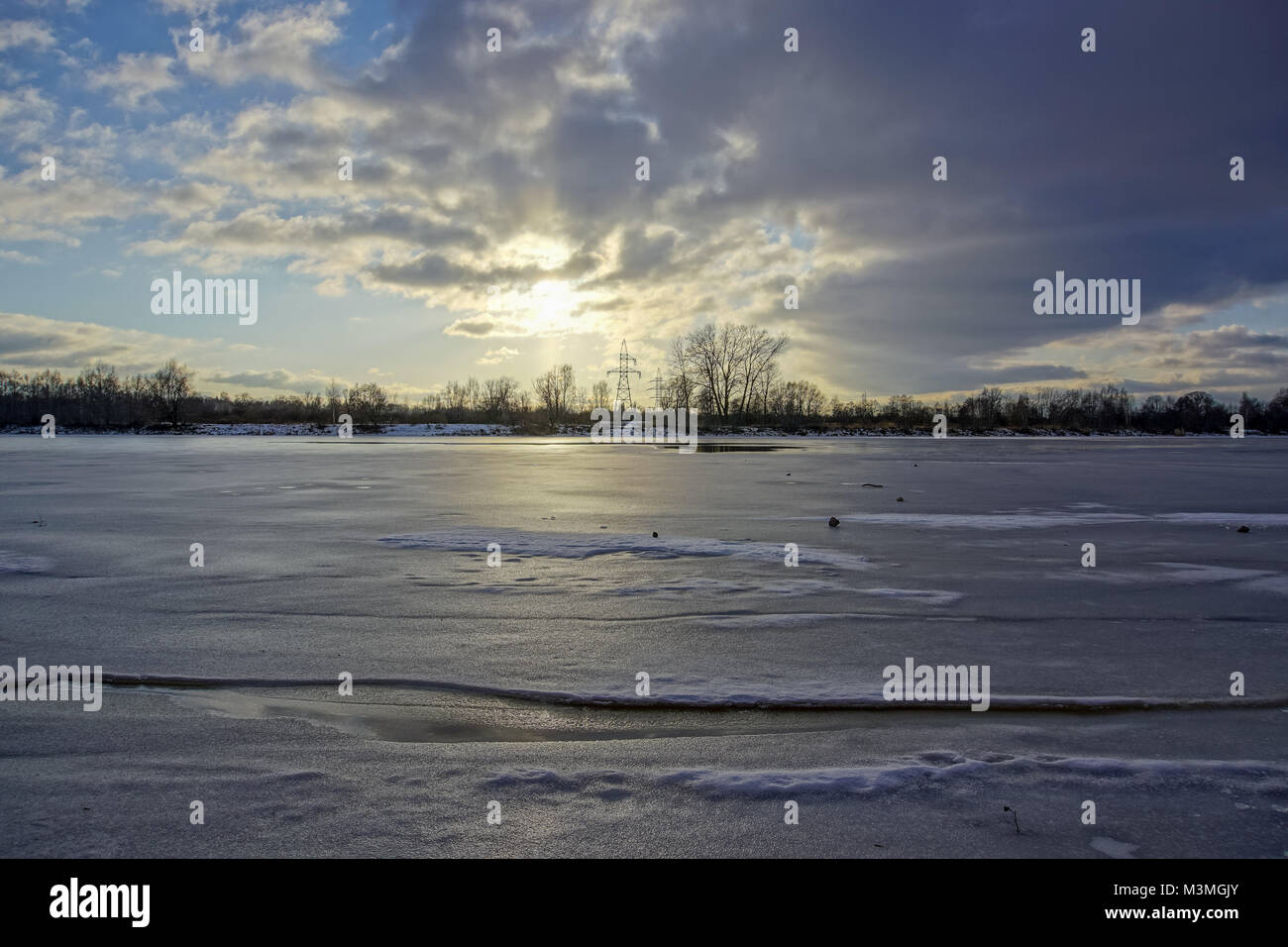 colorful winter sunset on frozen river ice with dramatic clouds Stock ...