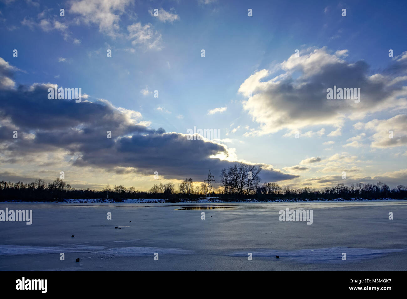 colorful winter sunset on frozen river ice with dramatic clouds Stock ...