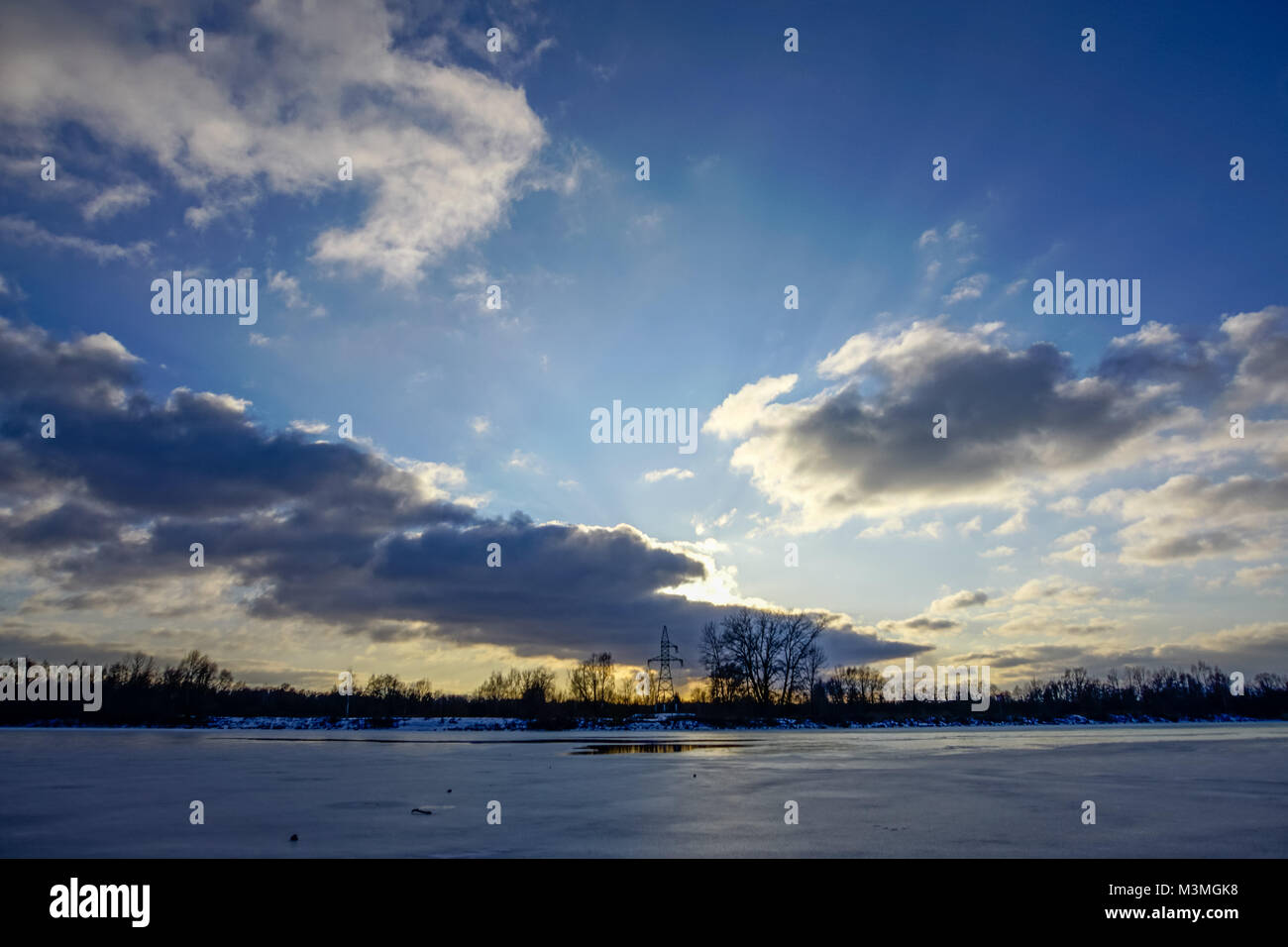 colorful winter sunset on frozen river ice with dramatic clouds Stock ...
