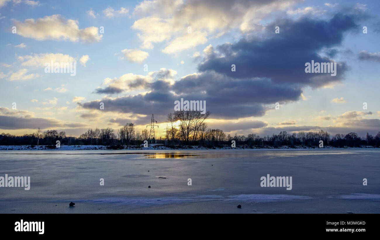 colorful winter sunset on frozen river ice with dramatic clouds Stock ...