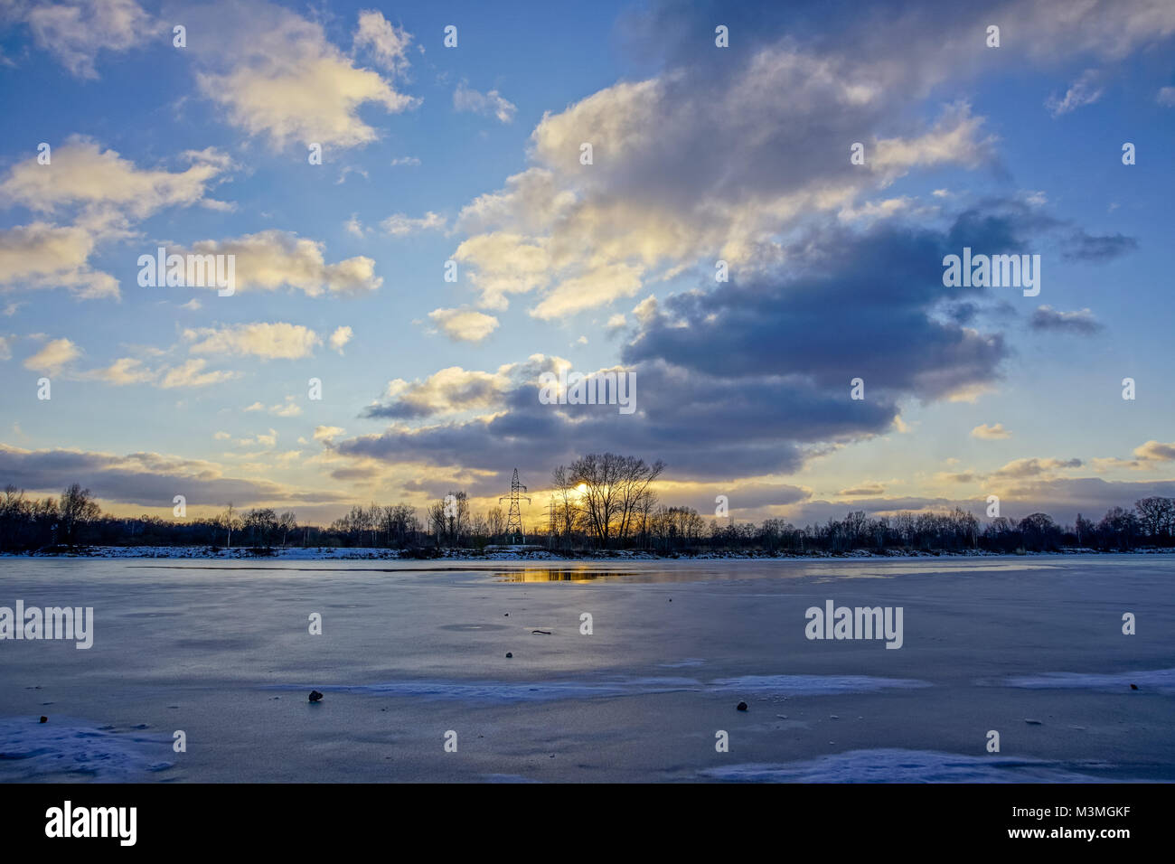 colorful winter sunset on frozen river ice with dramatic clouds Stock ...