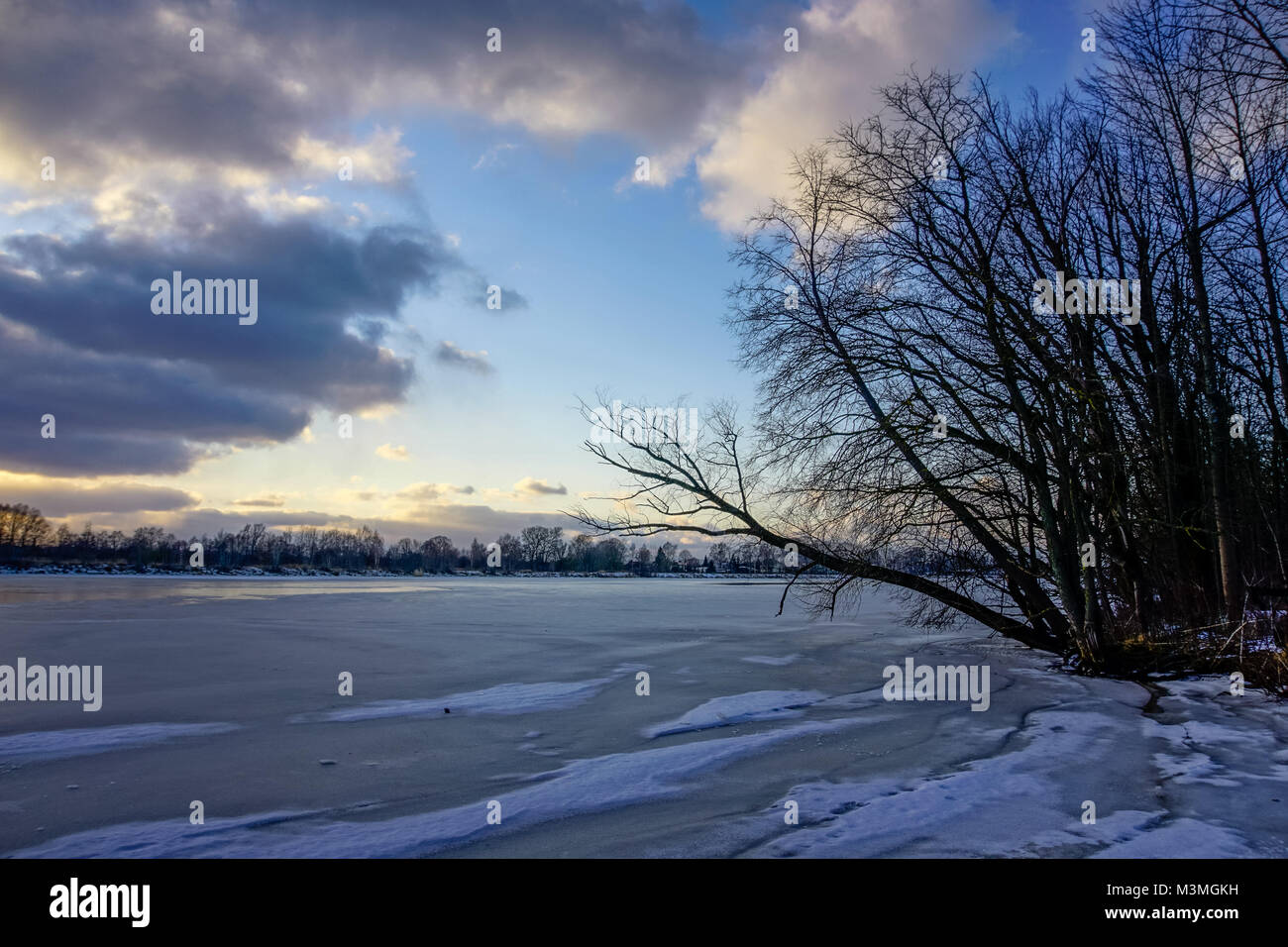 colorful winter sunset on frozen river ice with dramatic clouds Stock ...