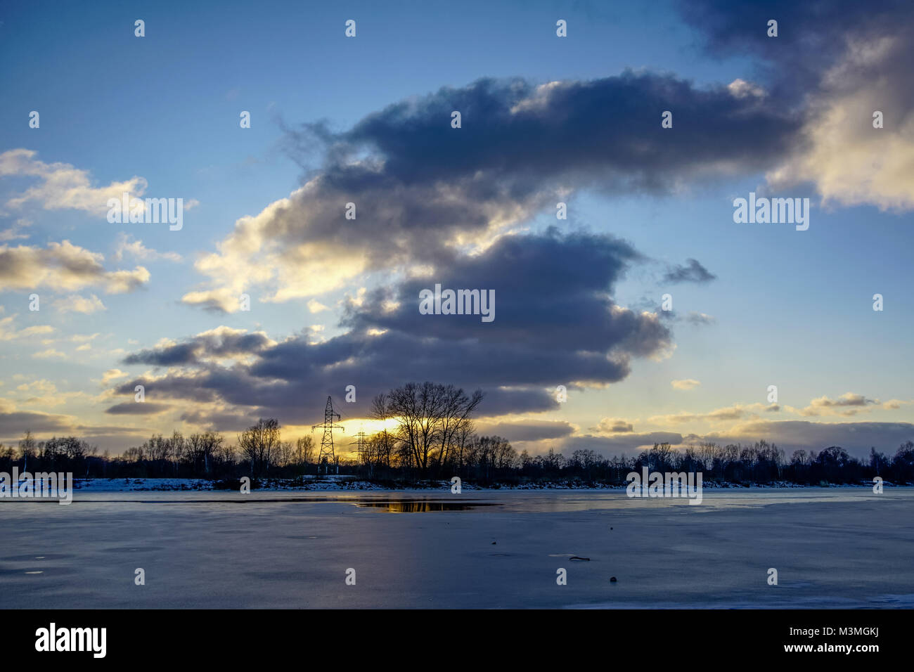 colorful winter sunset on frozen river ice with dramatic clouds Stock ...