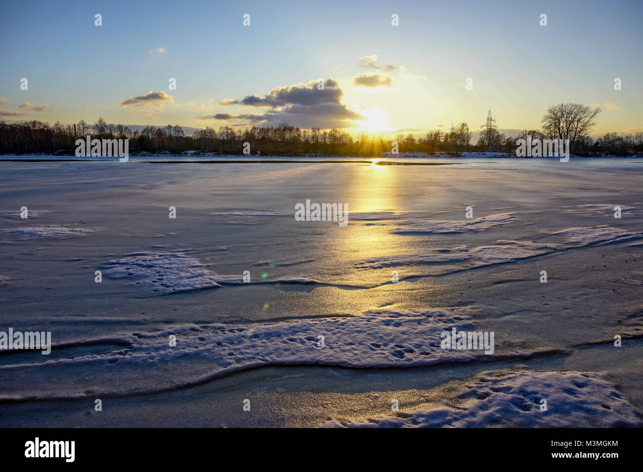 colorful winter sunset on frozen river ice with dramatic clouds Stock ...