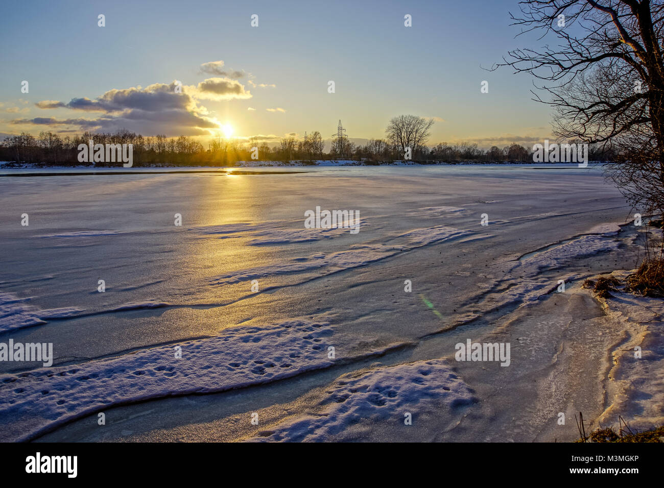 colorful winter sunset on frozen river ice with dramatic clouds Stock ...