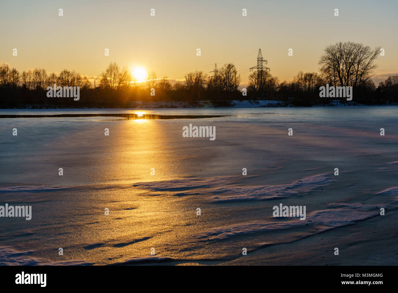 colorful winter sunset on frozen river ice with dramatic clouds Stock ...