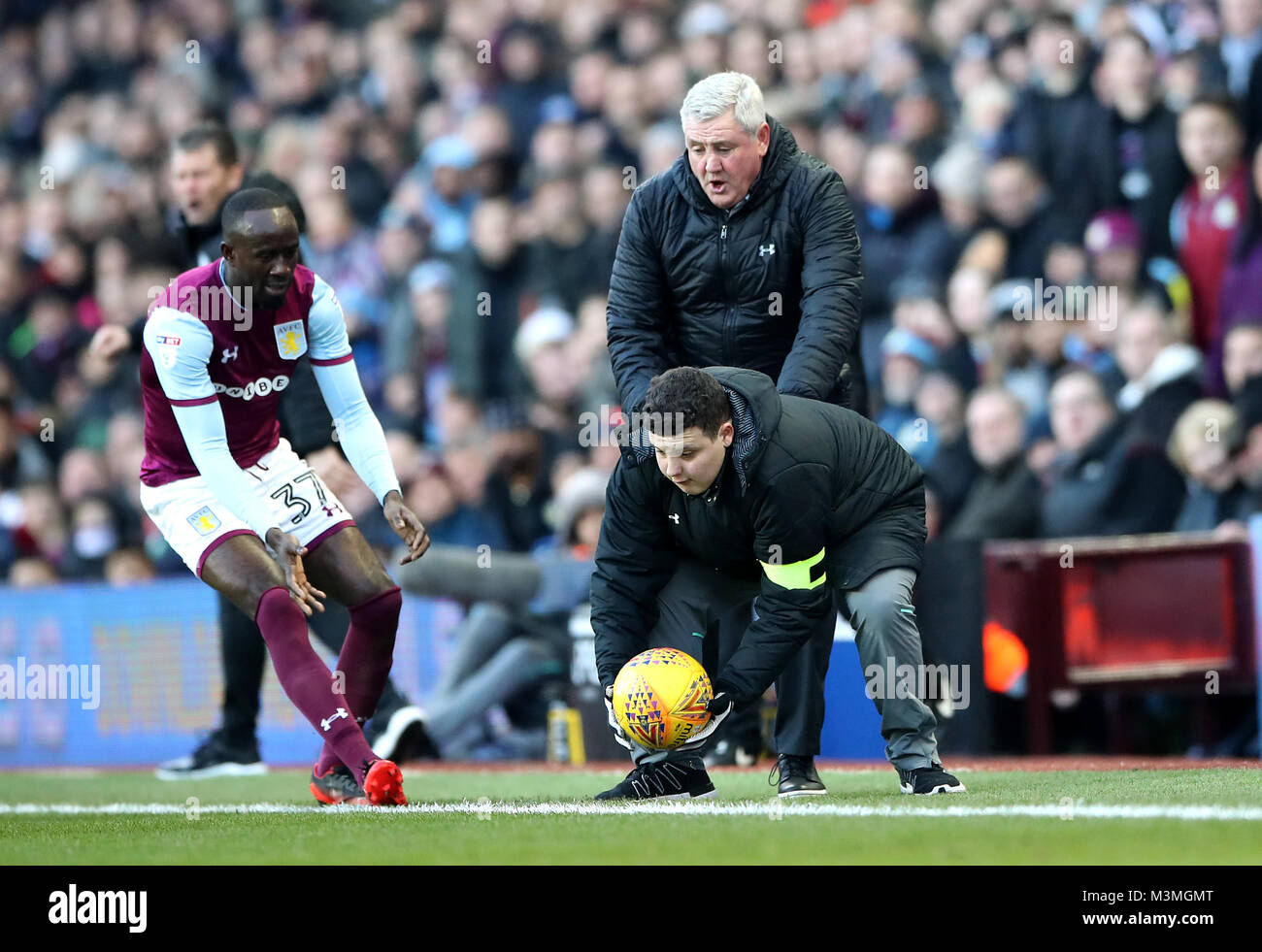 Aston Villa's Albert Adomah (left) reaches for a ball from a ball boy ...