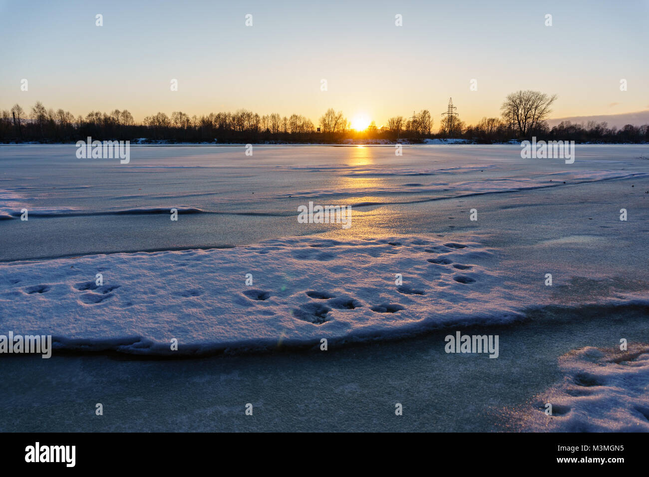 colorful winter sunset on frozen river ice with dramatic clouds Stock ...