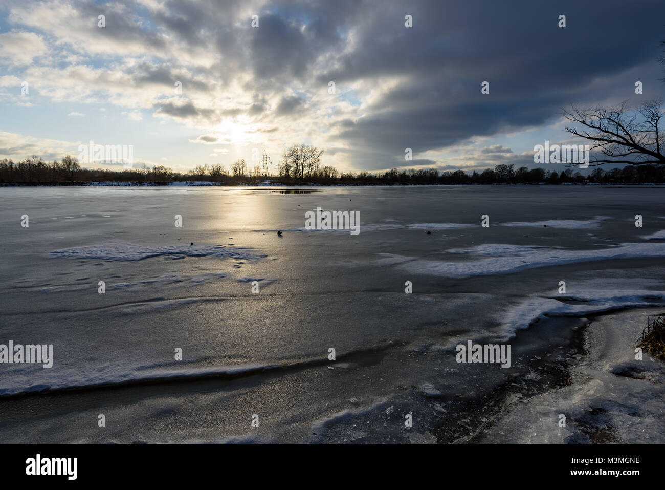 colorful winter sunset on frozen river ice with dramatic clouds Stock ...