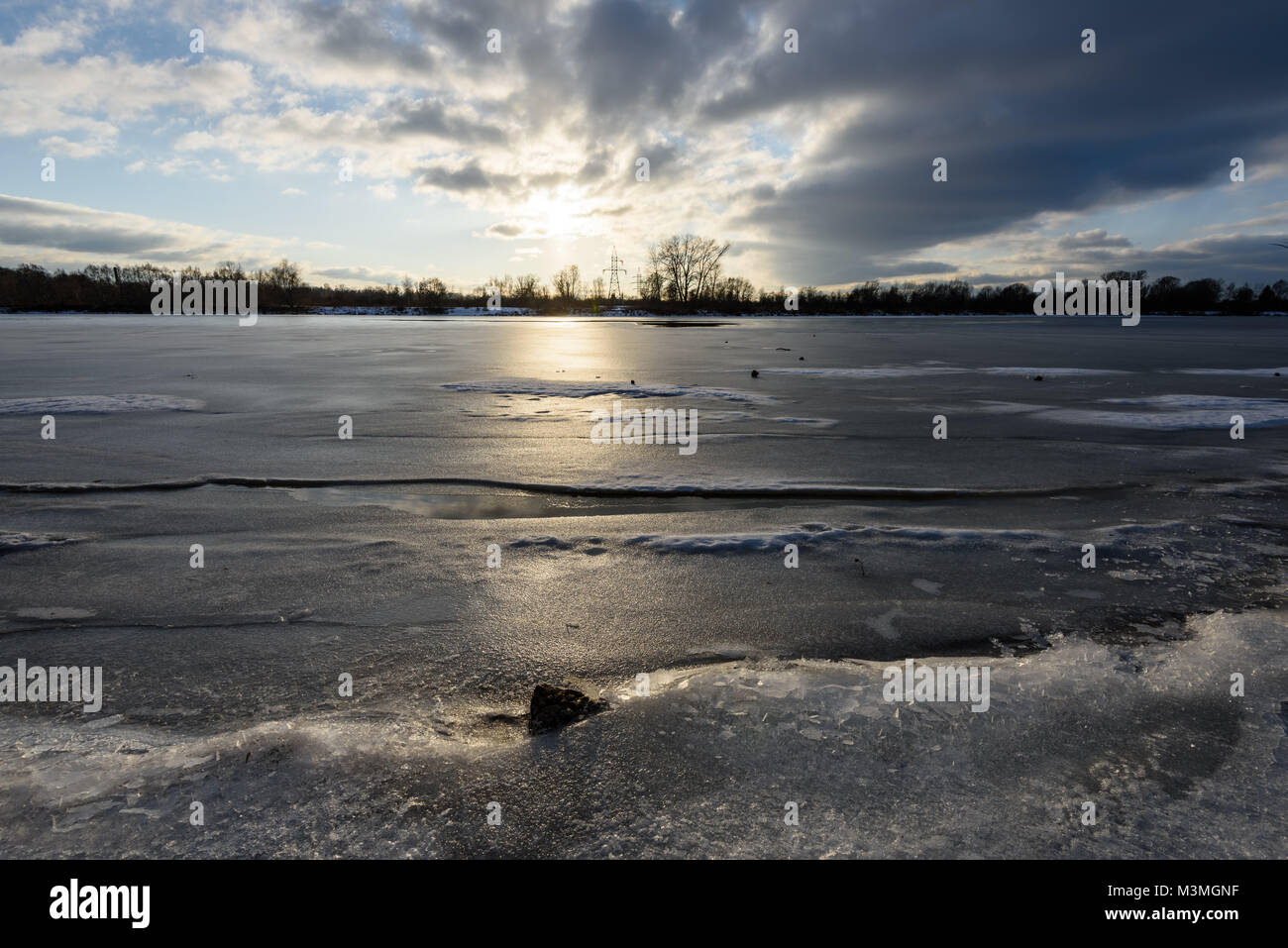 colorful winter sunset on frozen river ice with dramatic clouds Stock ...