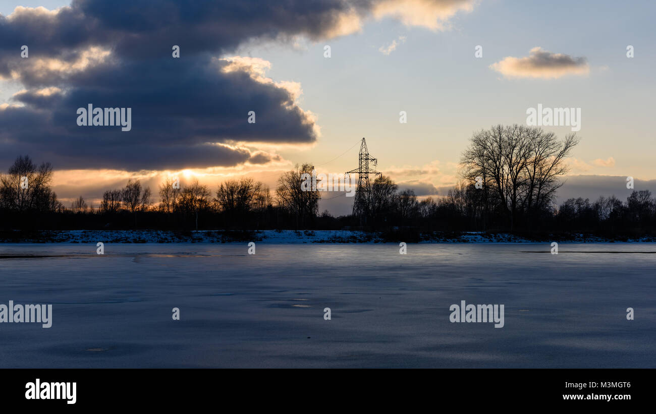 colorful winter sunset on frozen river ice with dramatic clouds Stock ...