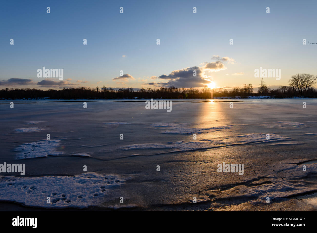 colorful winter sunset on frozen river ice with dramatic clouds Stock ...