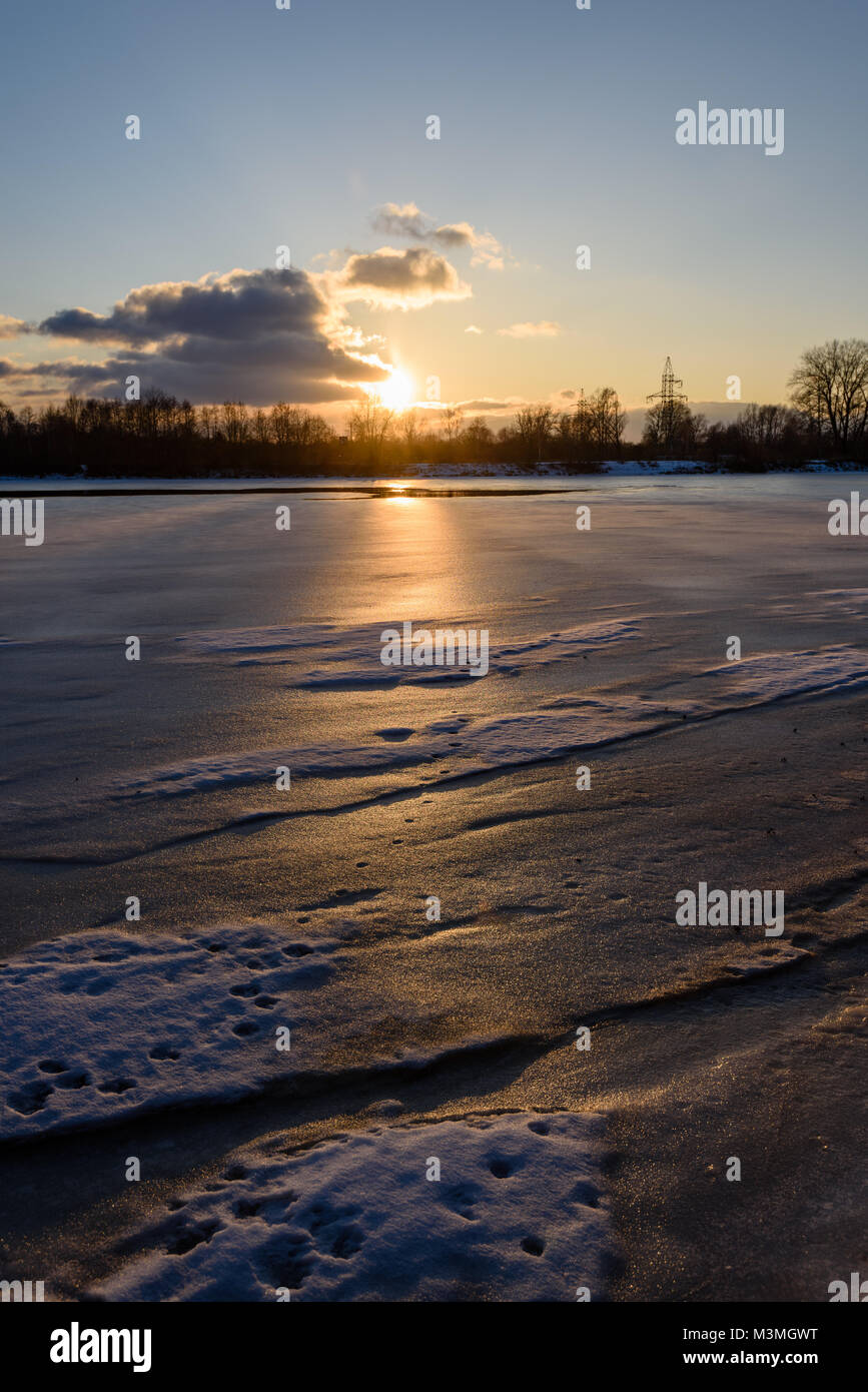 colorful winter sunset on frozen river ice with dramatic clouds Stock ...