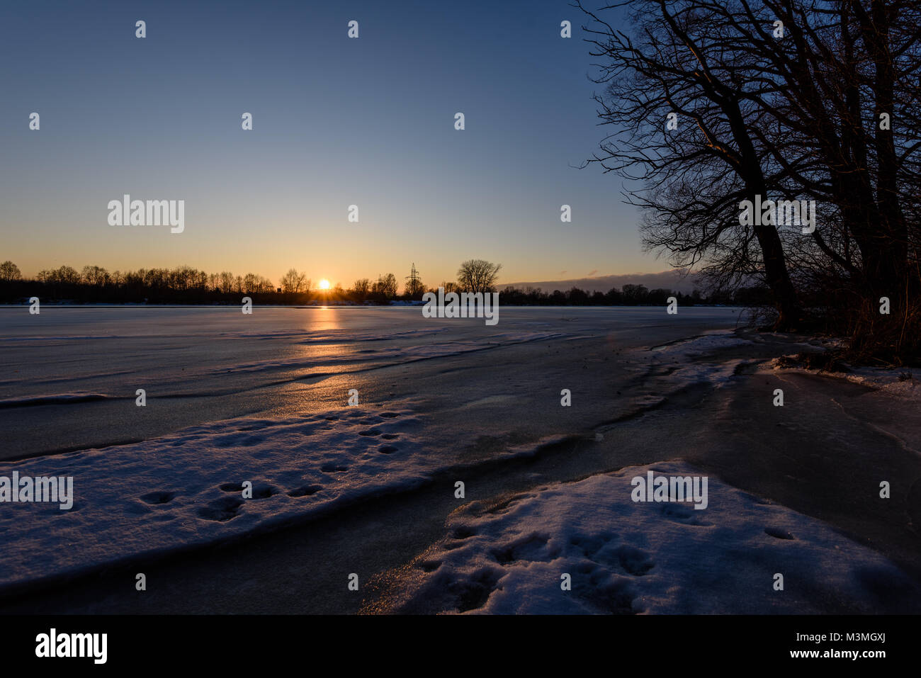 colorful winter sunset on frozen river ice with dramatic clouds Stock ...